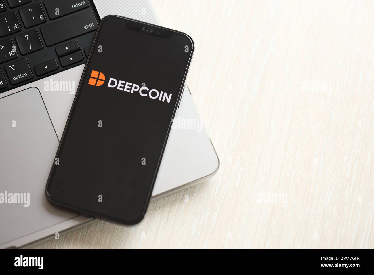 KYIV, UKRAINE - MARCH 15, 2024 Deepcoin logo on iPhone display screen ...