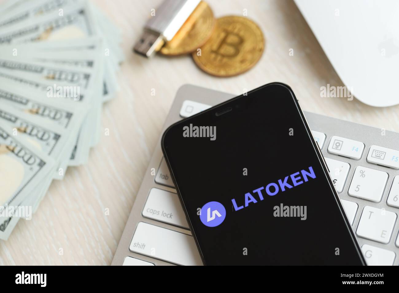 KYIV, UKRAINE - MARCH 15, 2024 Latoken logo on iPhone display screen on white keyboard with ...