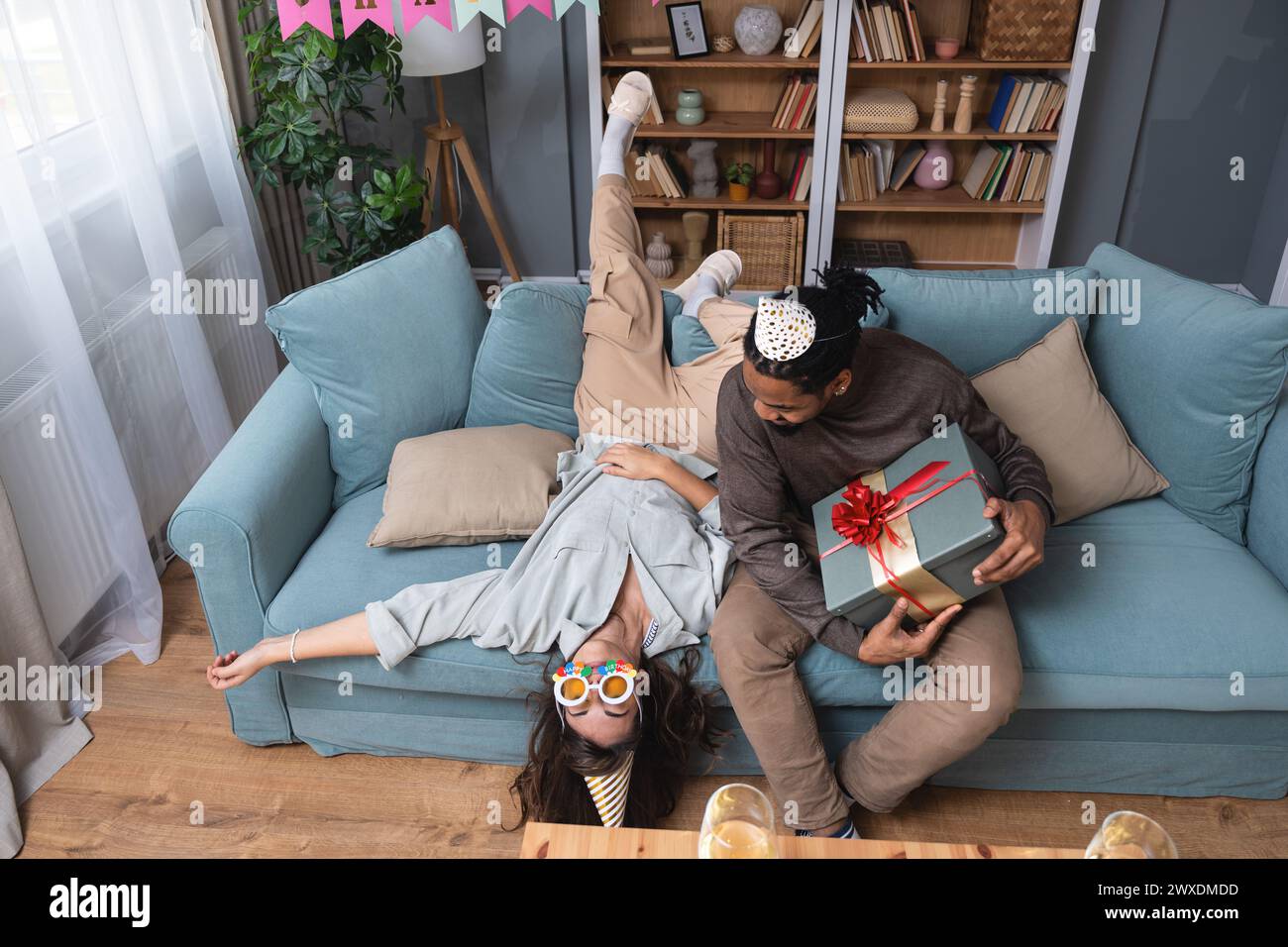 Crazy birthday party. Young couple celebrating birthday in their ...