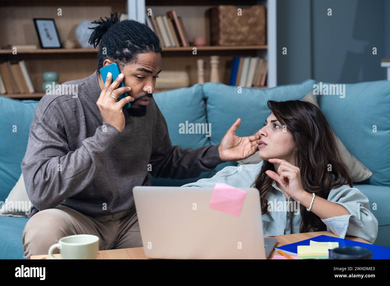 Young business people, couple, working at home, ordering food delivery ...