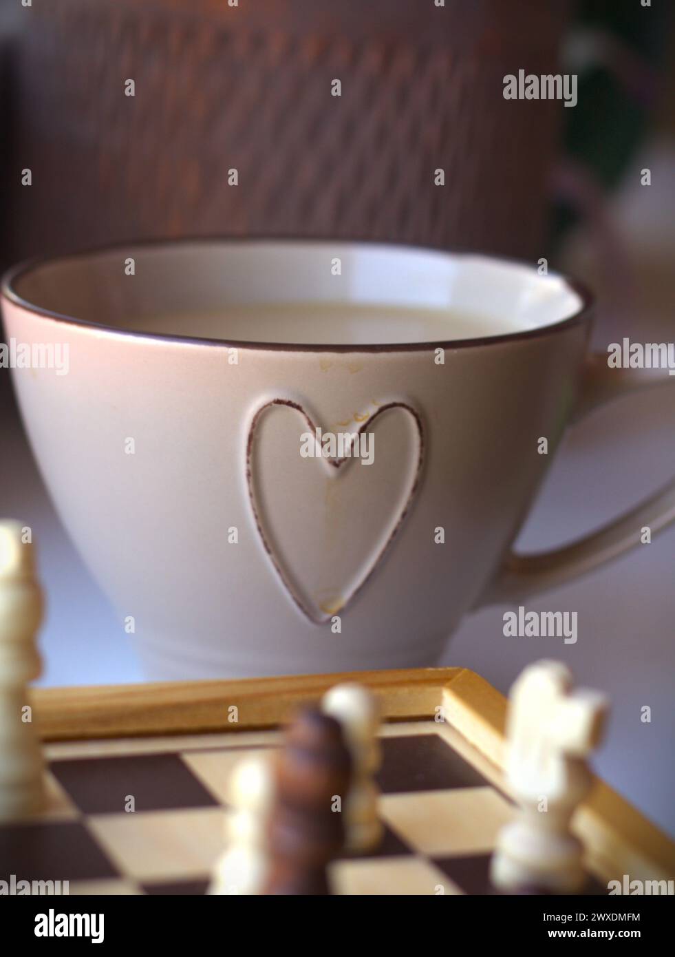 Chess game - chess board with the chess pieces and a coffee mug ...