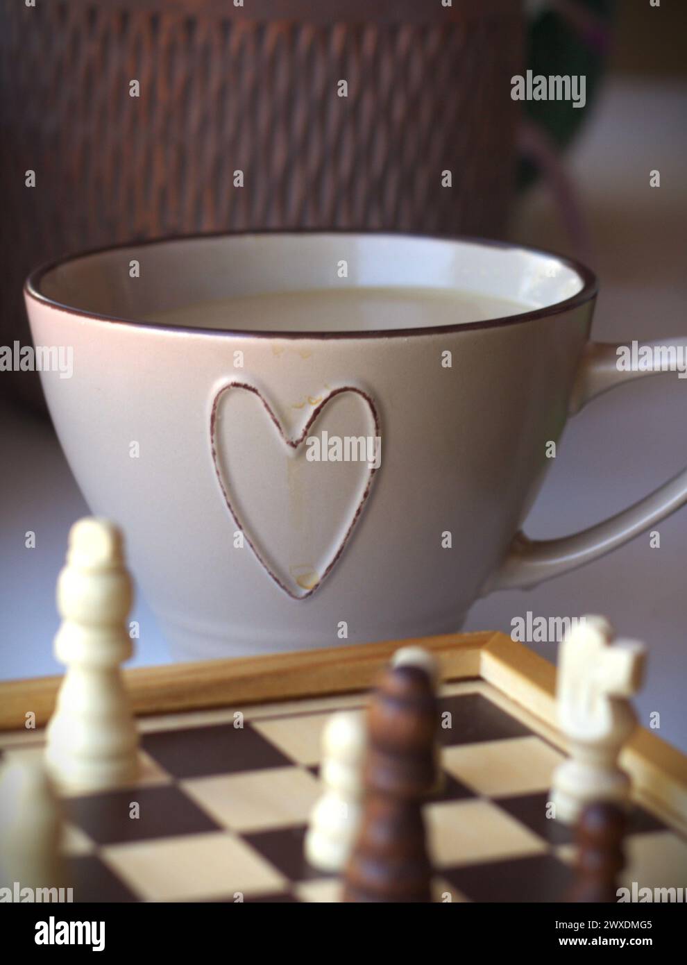 Chess game - chess board with the chess pieces and a coffee mug ...