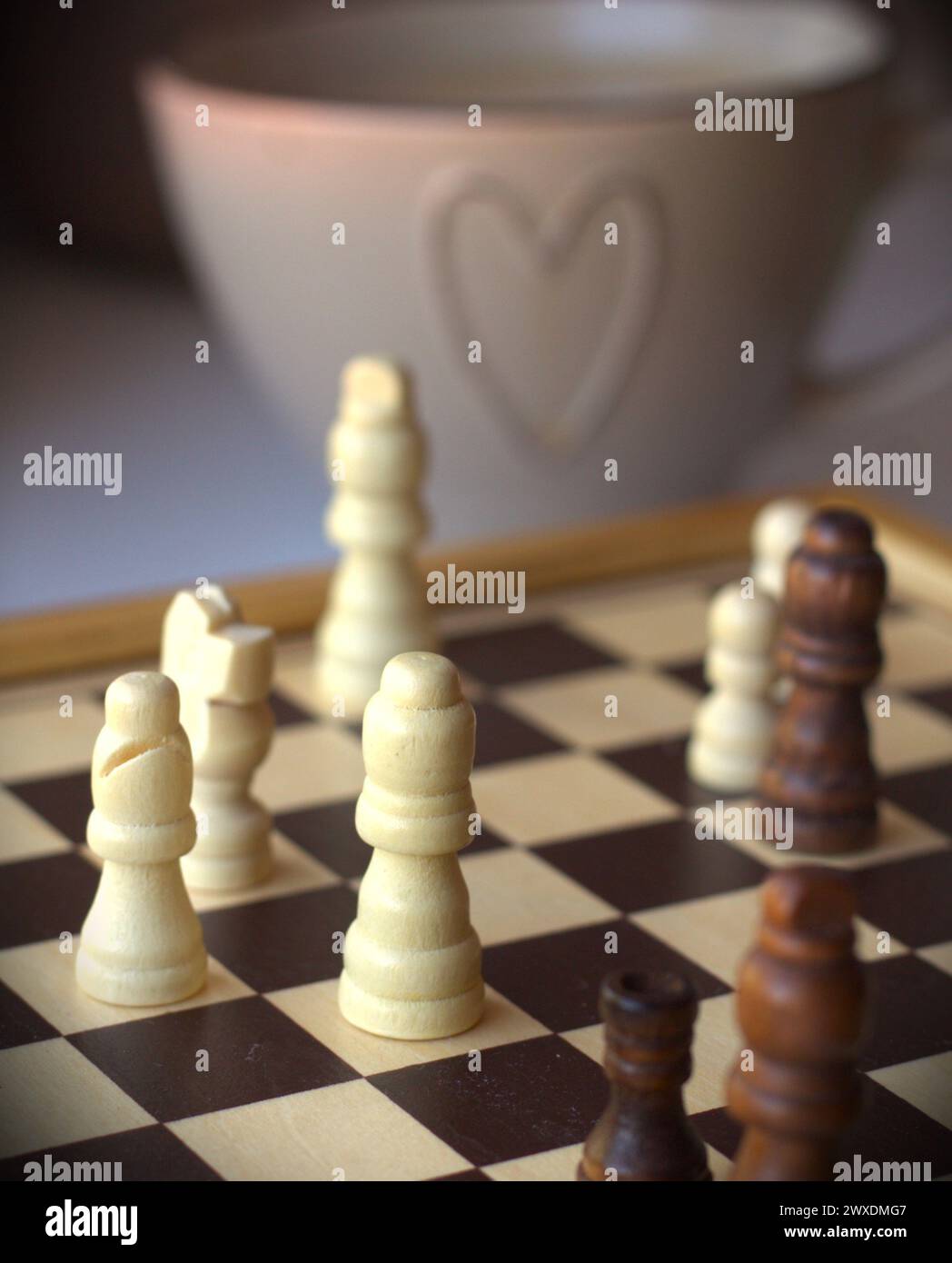 Chess game - chess board with the chess pieces and a coffee mug ...