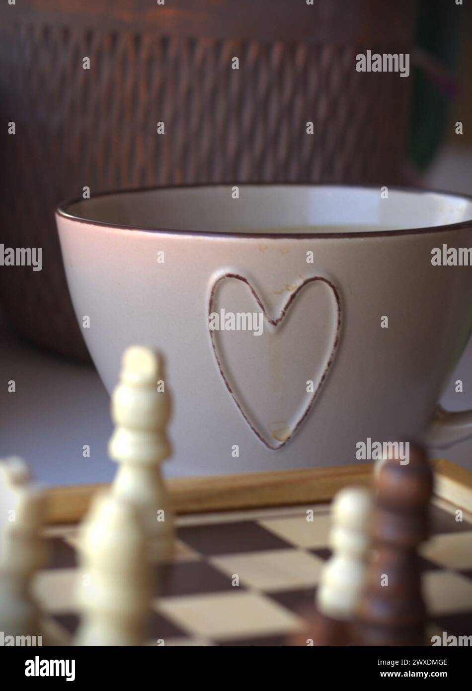 Chess game - chess board with the chess pieces and a coffee mug ...