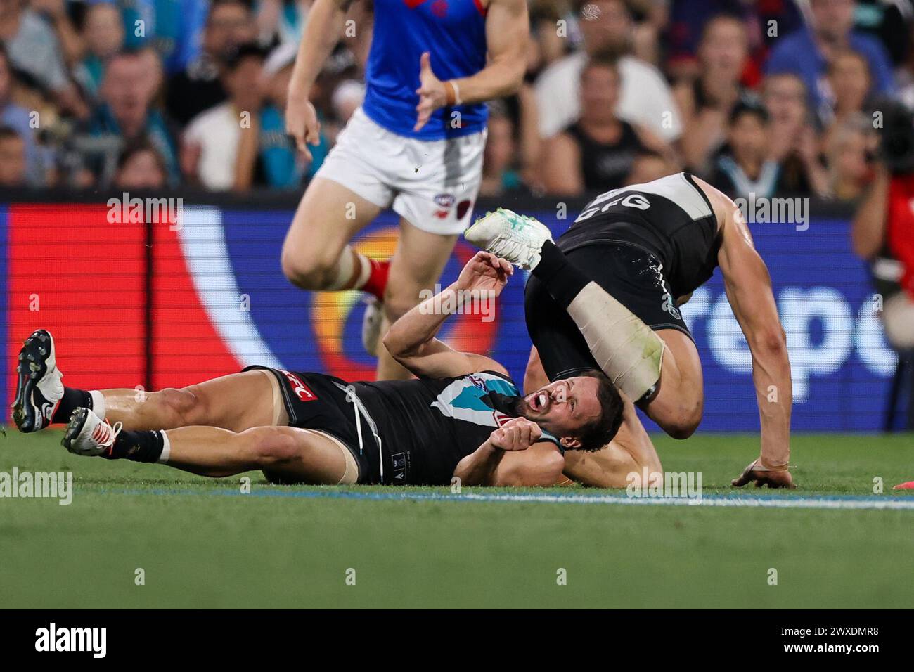 Adelaide, Australia. 30th Mar, 2024. Travis Boak of the Power clashes ...
