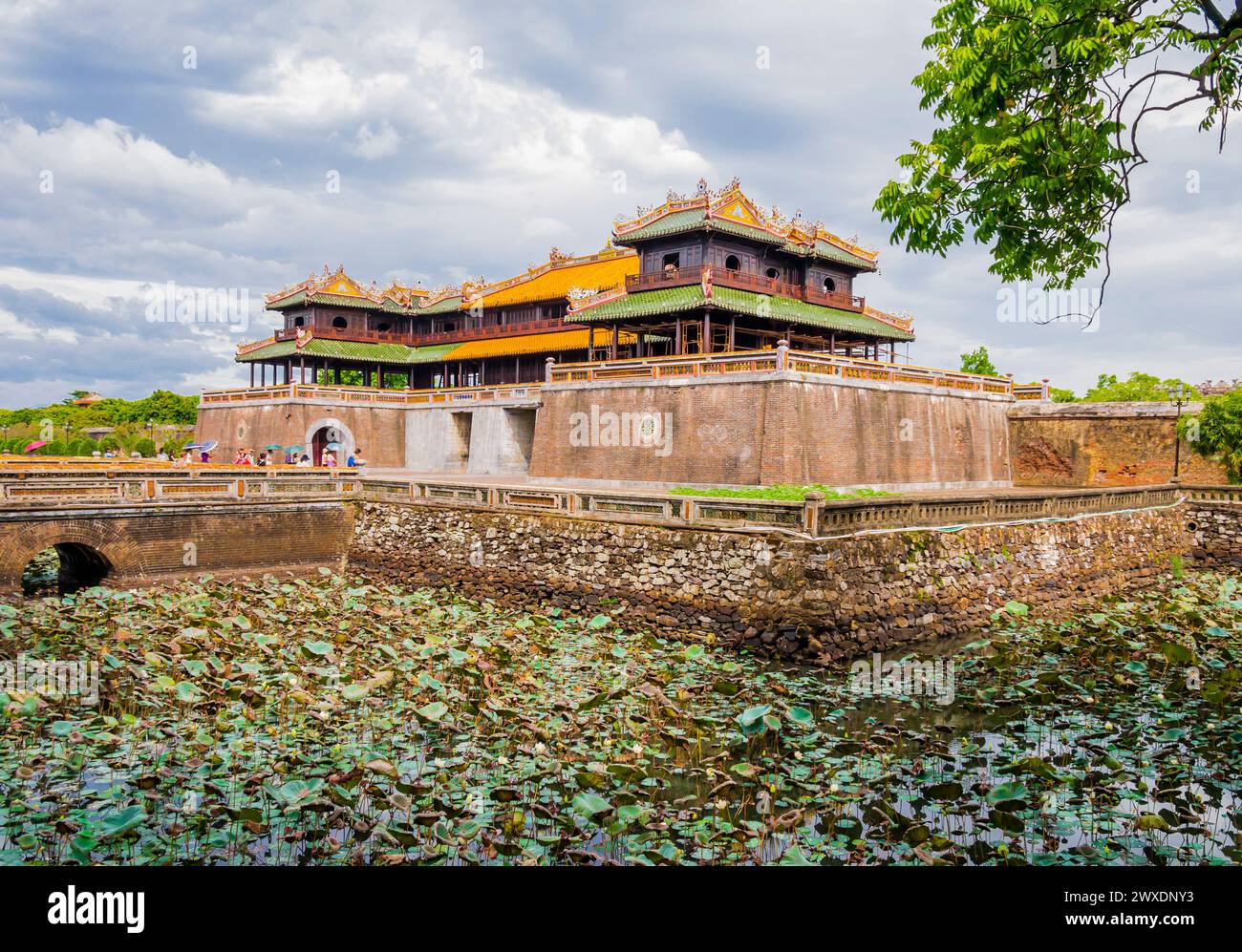 Tourists sightseeing the imperial citadel of Hue entering through the ...