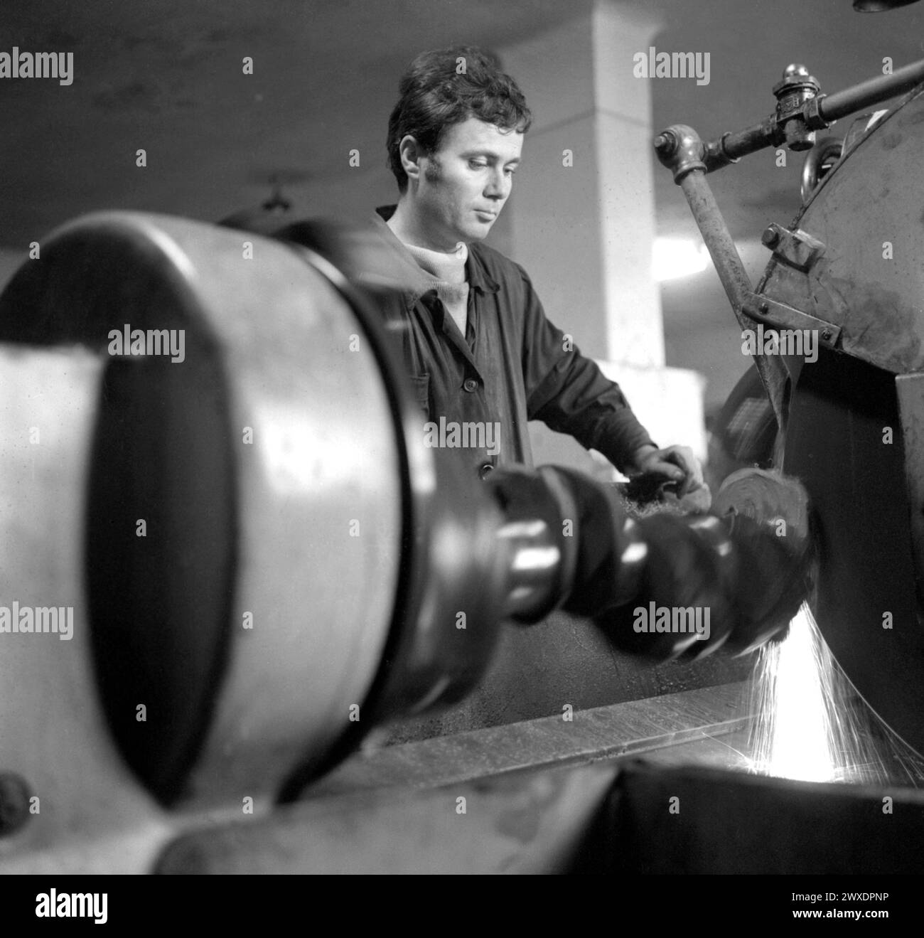 Socialist Republic of Romania in the 1970s. Worker on a metal lathe in ...