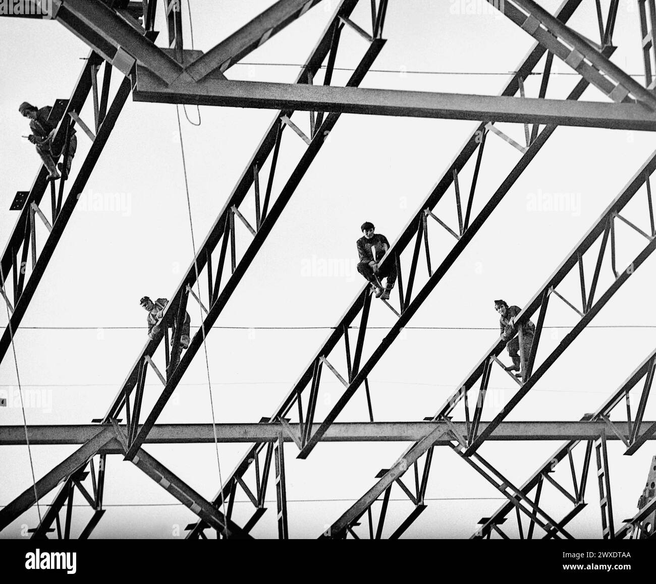 Socialist Republic of Romania in the 1970s. Workers building the large steel frame of a state ...