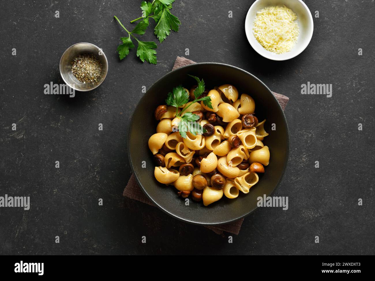 Pipe rigate pasta with roasted mushrooms garnished with fresh parsley ...