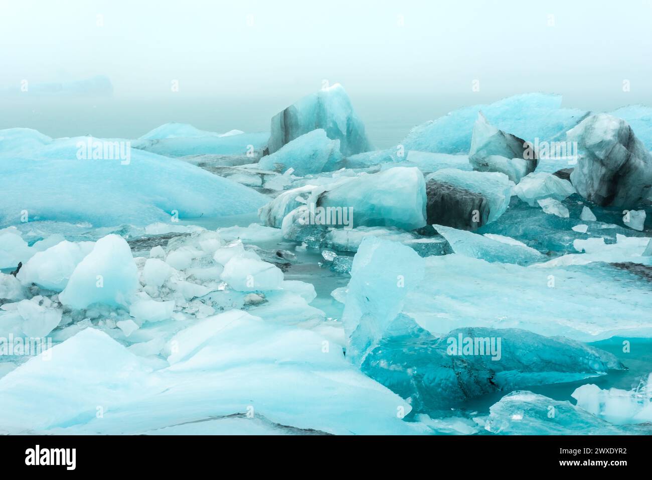 Floating iceberg of the Jokulsarlon Glacier Lagoon under heavy rain ...