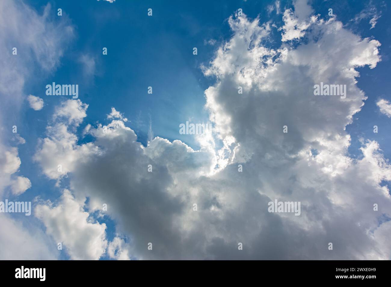 Some cumulus cloud is covering the sun. Rays through clouds. Frog eye ...