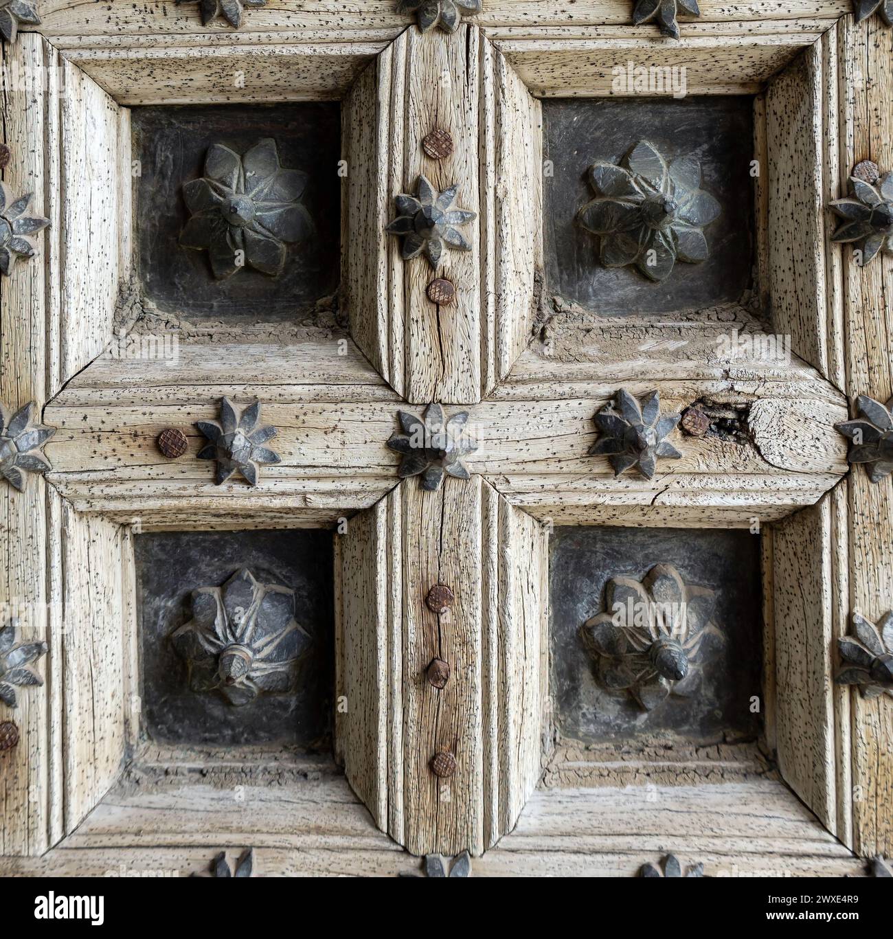 fragment of antique old door made of light unpainted wood and metal ...