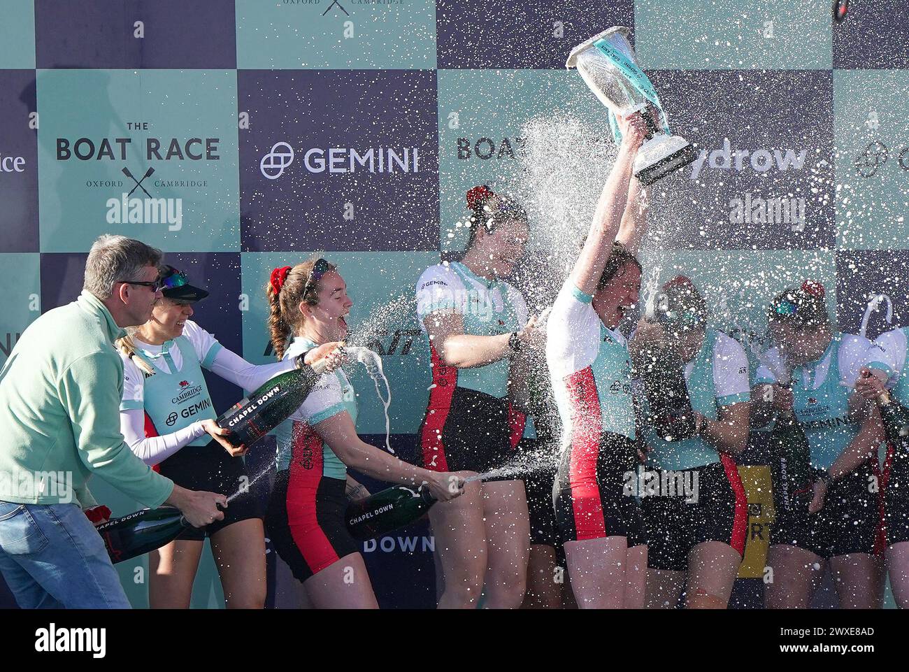 Cambridge Women's President Jenna Armstrong lifts the trophy with the ...