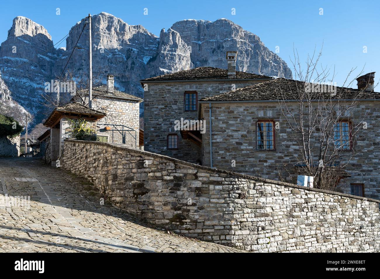 Stone houses of traditional architecture and cobble-stone narrow street ...
