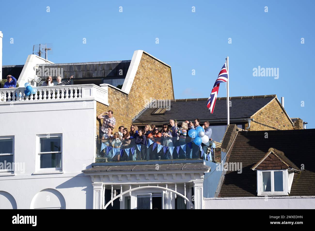 Spectators watch 169th Men's Gemini Boat Race 2024 on the River Thames ...