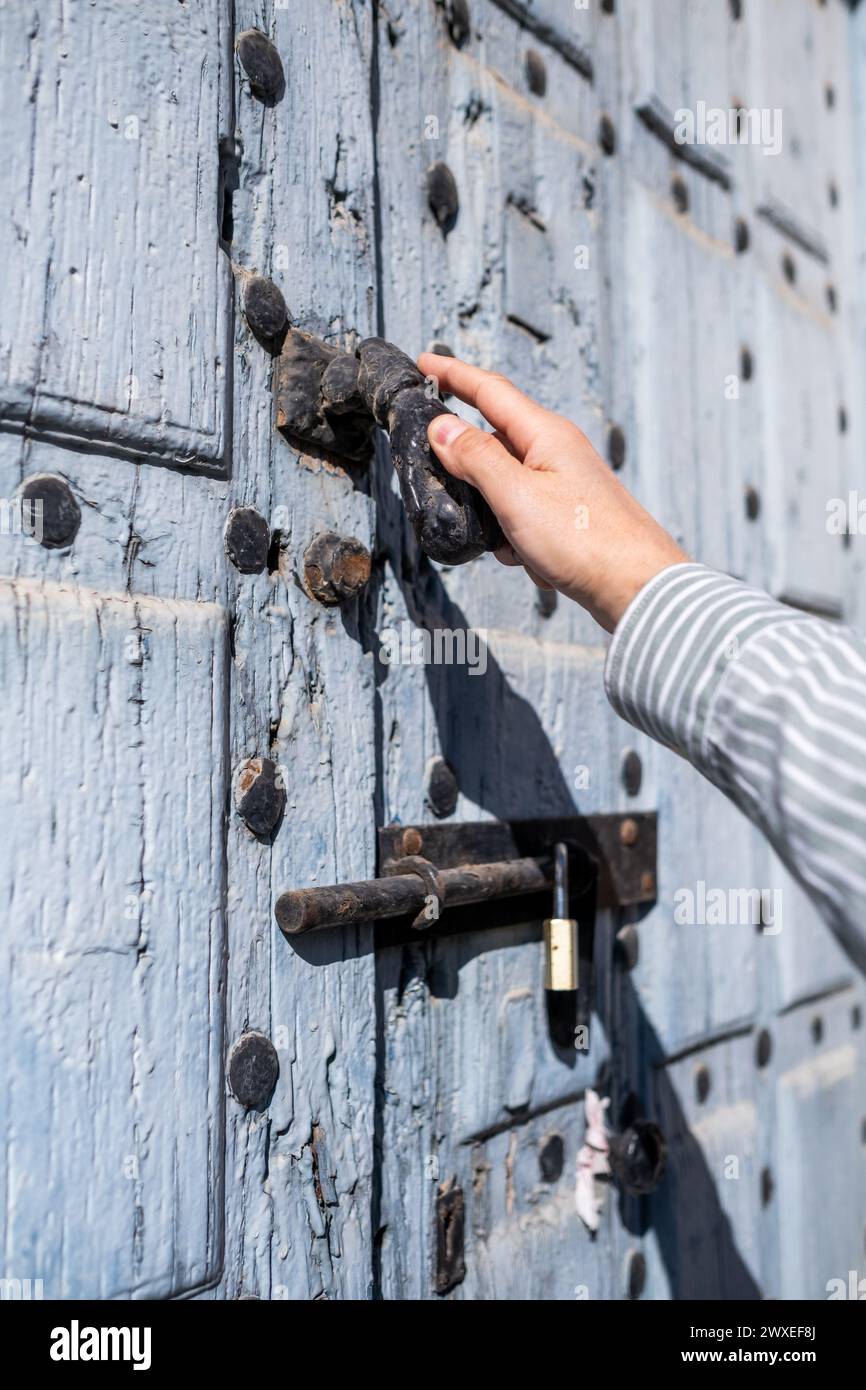 Closeup view of a man´s hand knocking on the wooden old door, male ...