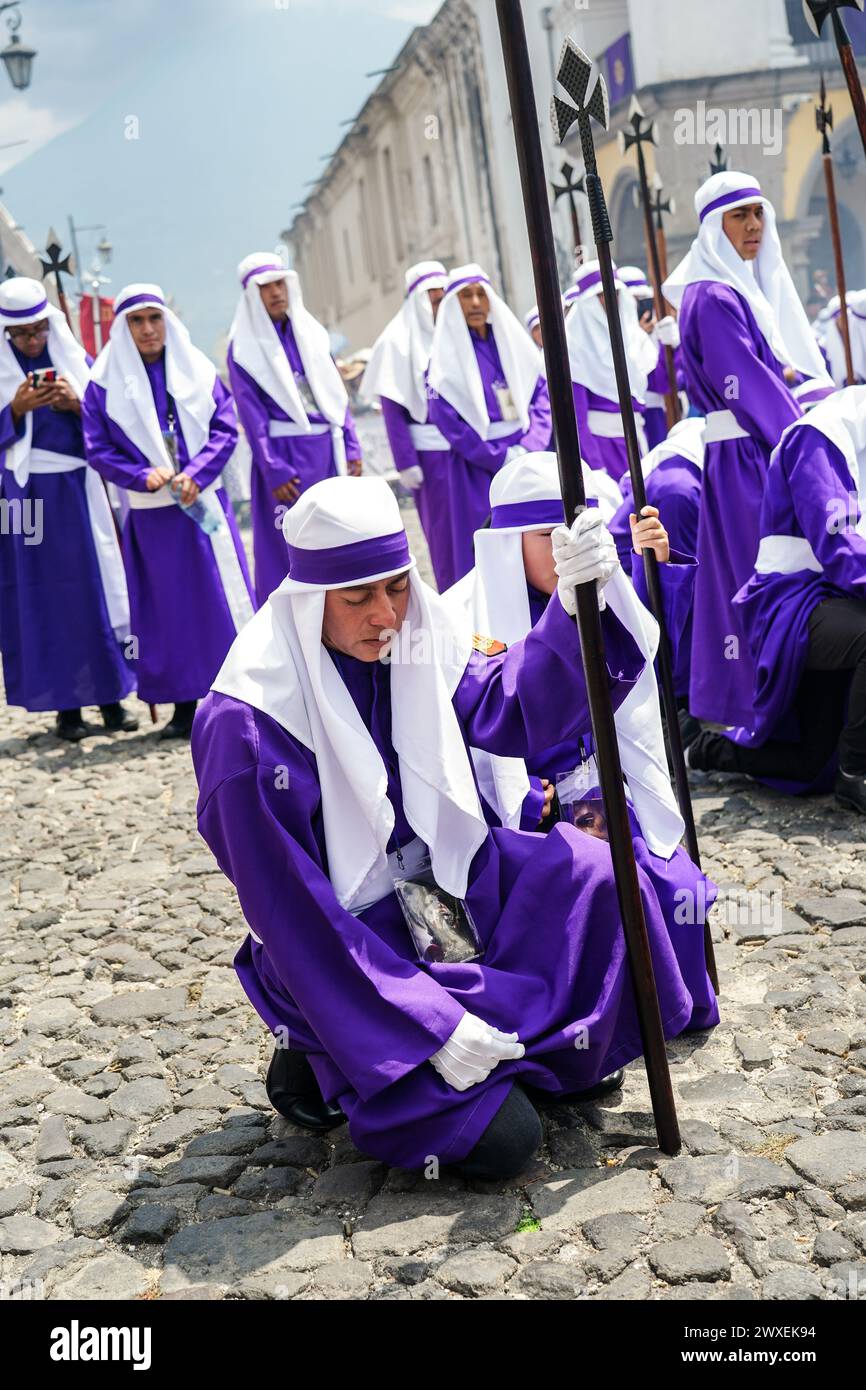 Antigua, Guatemala. 29th Mar, 2024. Catholic penitents kneel in prayer ...