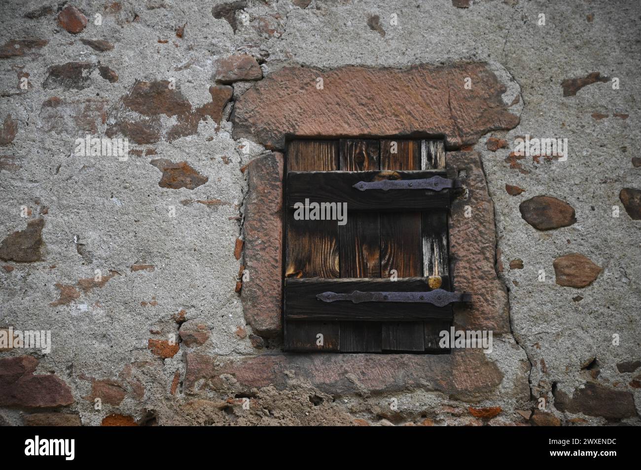 Antique wine cellar street level window on a handcrafted stone wall in ...