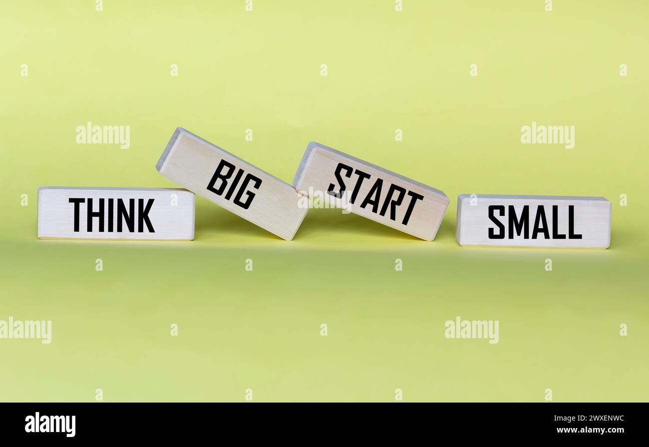 Conceptual words Think Big, Start Small on wooden blocks on a beautiful ...