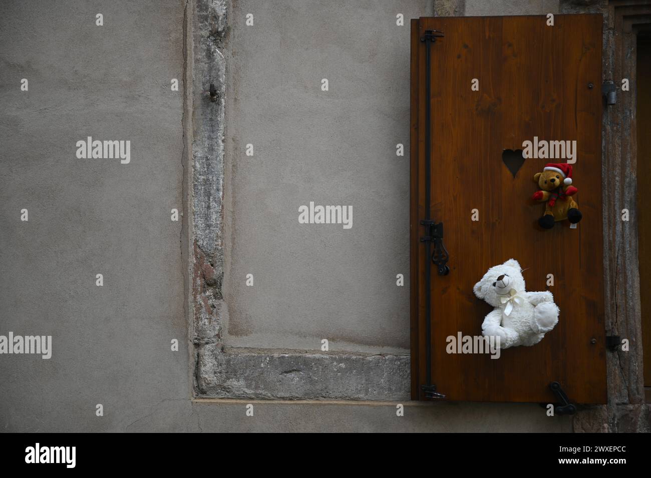 Teddy bear decoration on the wooden shutter of a rural house in ...