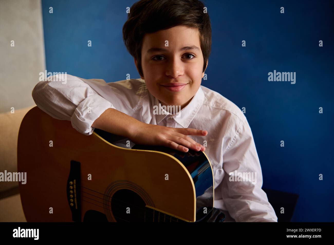 Latin American teenager, adorable school boy musician guitarist smiling ...