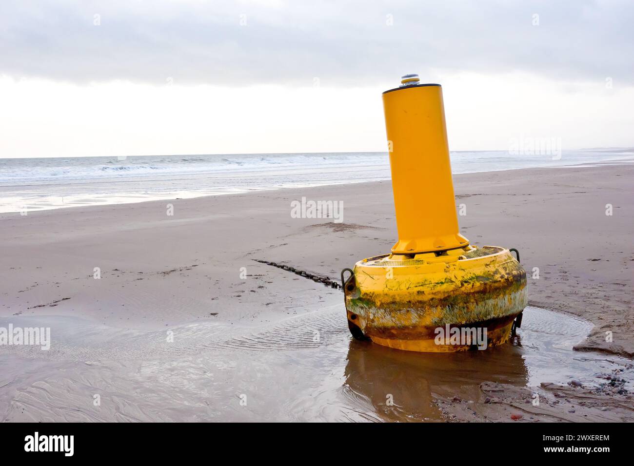 A yellow warning or navigation buoy ripped from its moorings in the sea ...