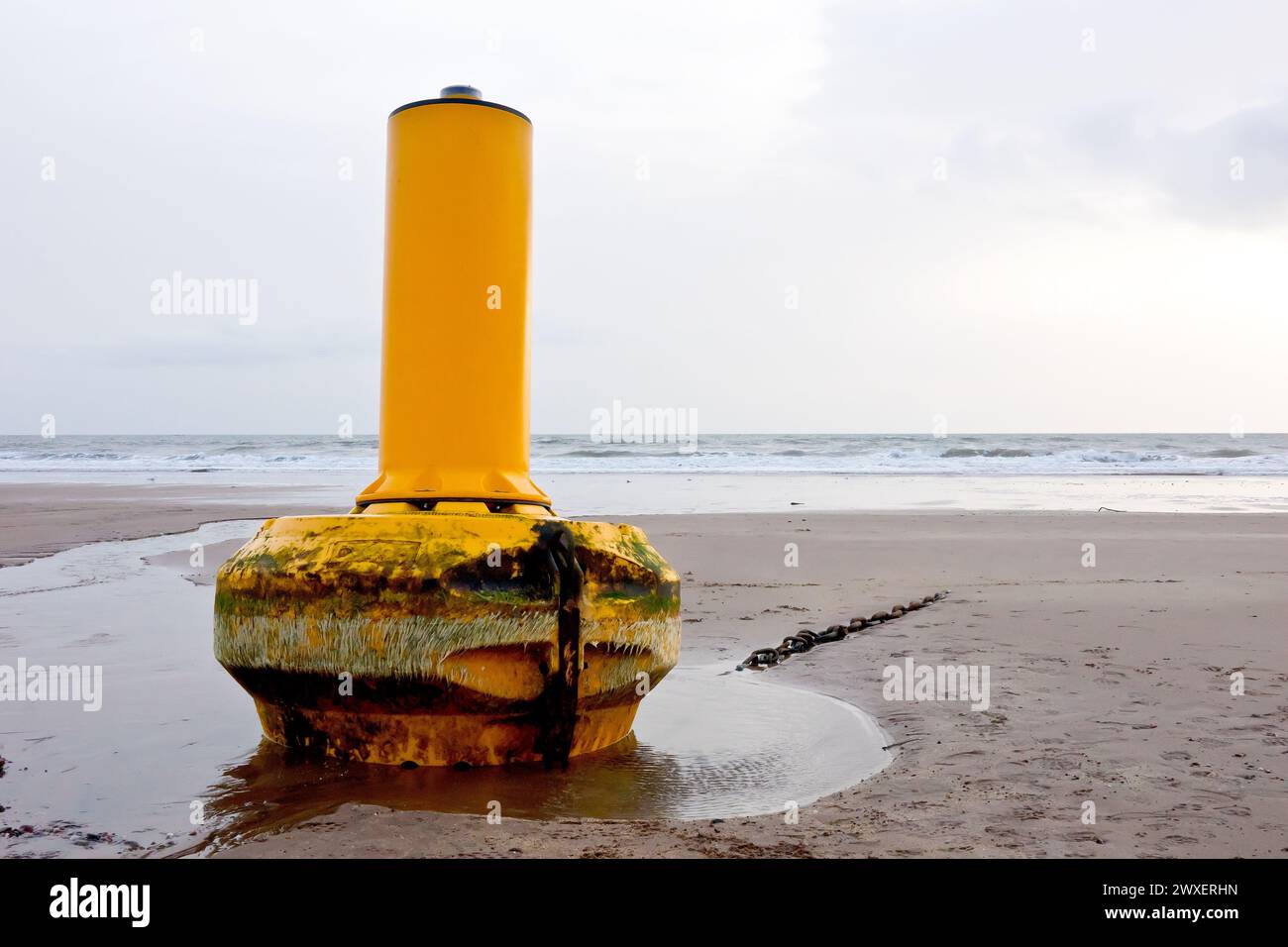 A yellow warning or navigation buoy ripped from its moorings in the sea ...