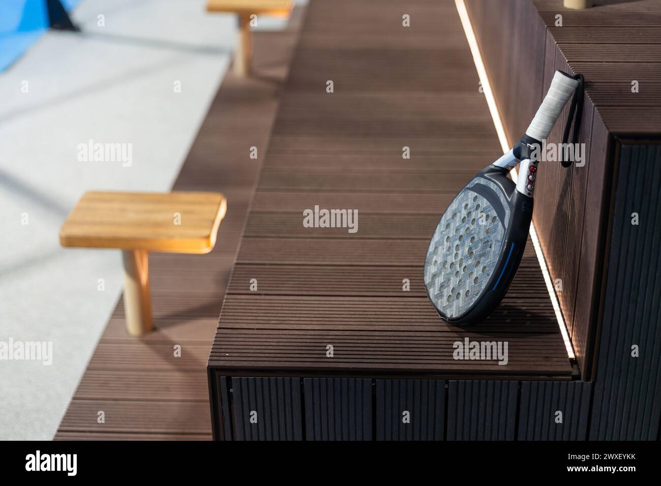Paddle tennis: Paddel racket and ball in front of an outdoor court ...