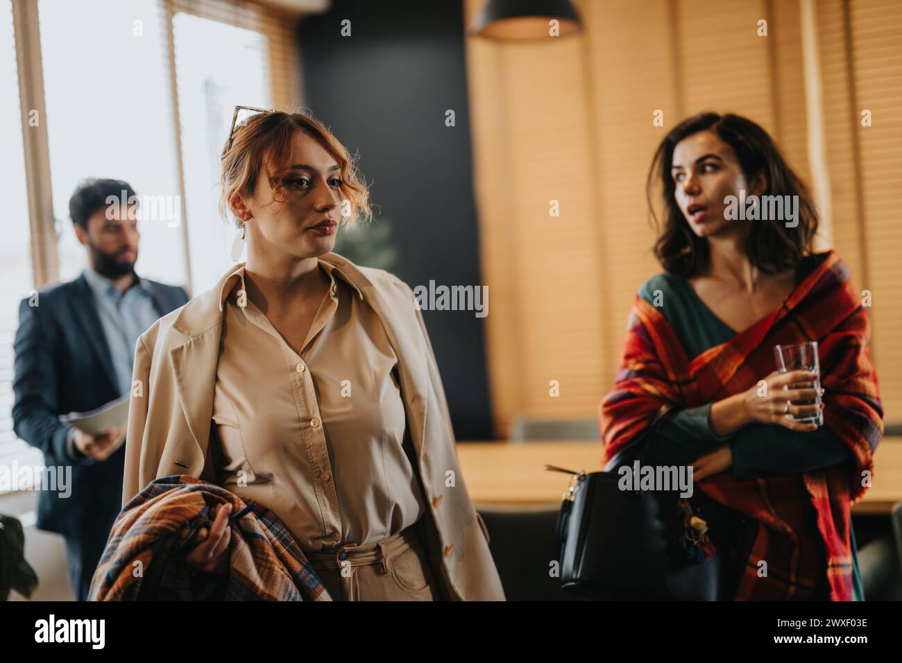 As the workday ended, employees are leaving the office, having a ...