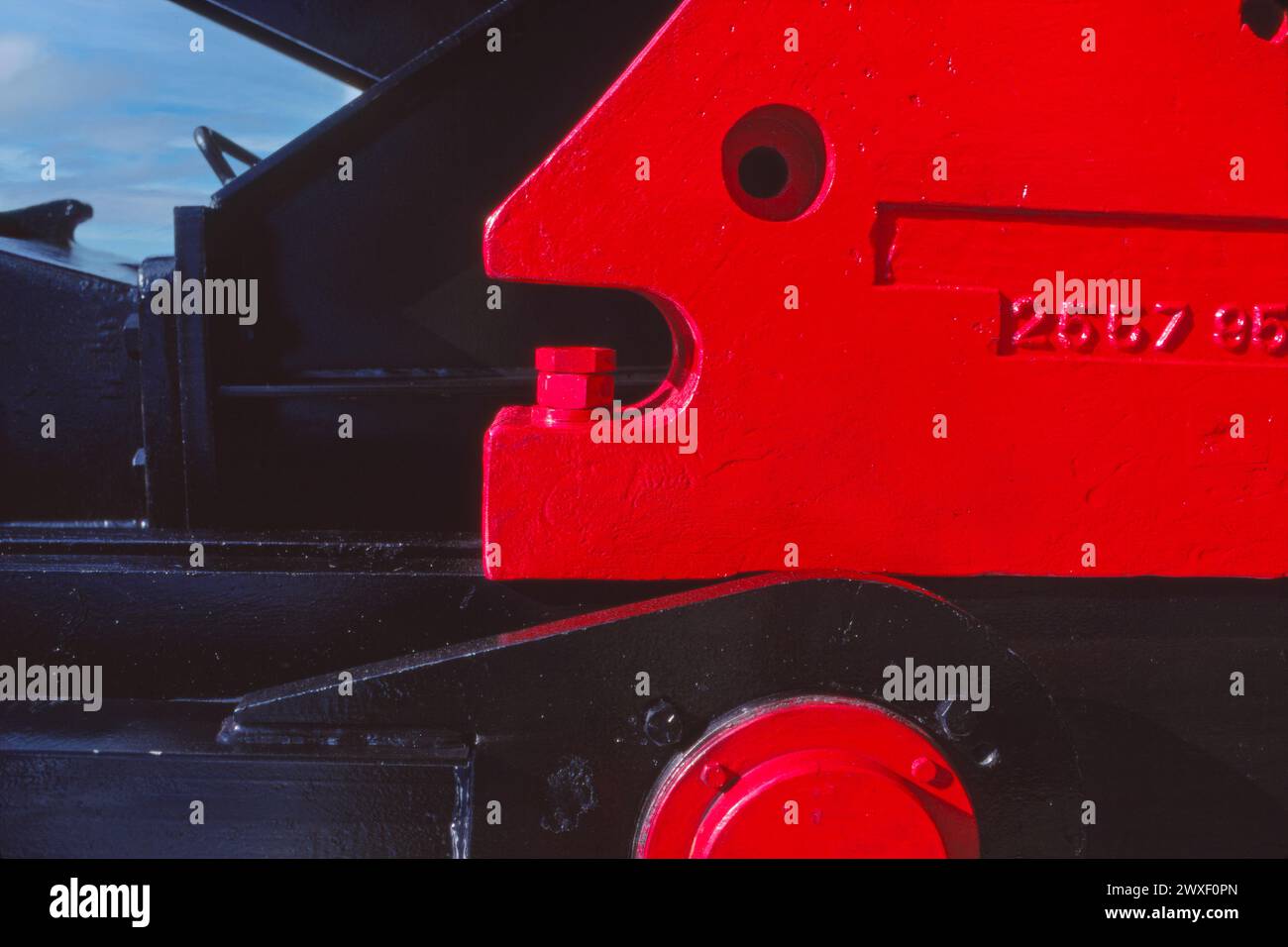 Close-up of a red industrial machinery part with focus on the ...