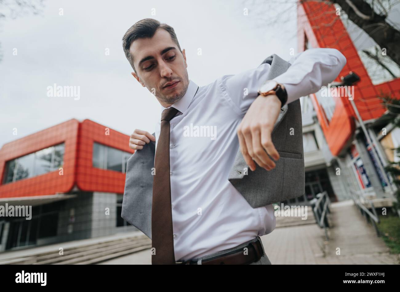 A professional male lawyer dressed in a suit holding a red clipboard ...