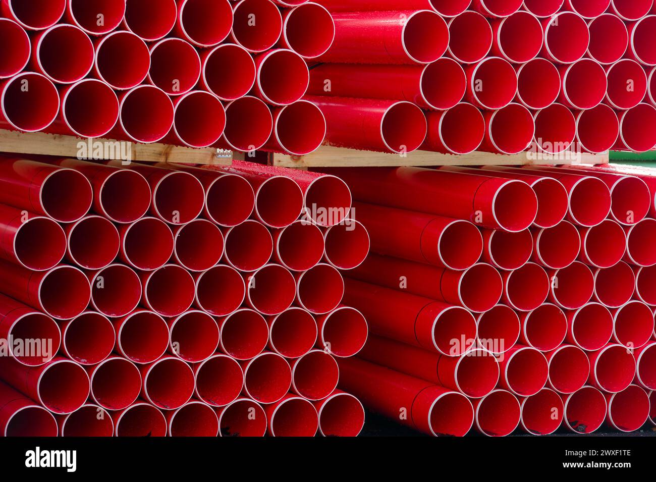 Plastic ducts stacked for underground cables at construction site Stock ...