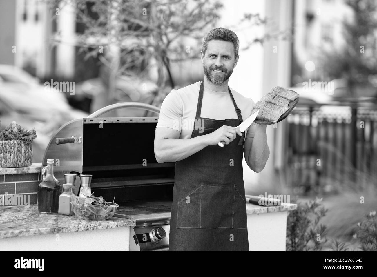 Man cooking on barbecue Black and White Stock Photos & Images - Alamy
