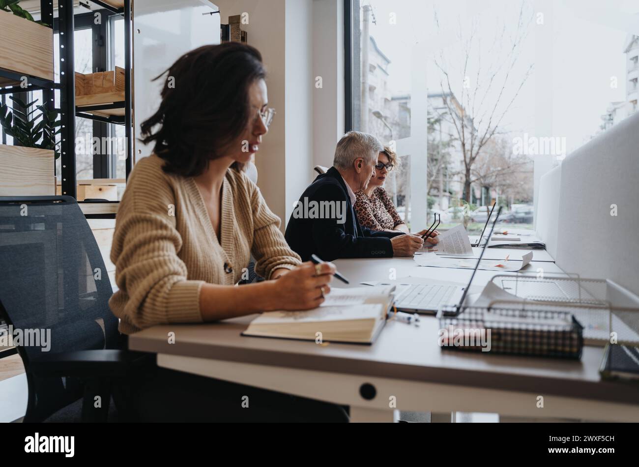 Office workers collaborating discussing strategies hi-res stock ...
