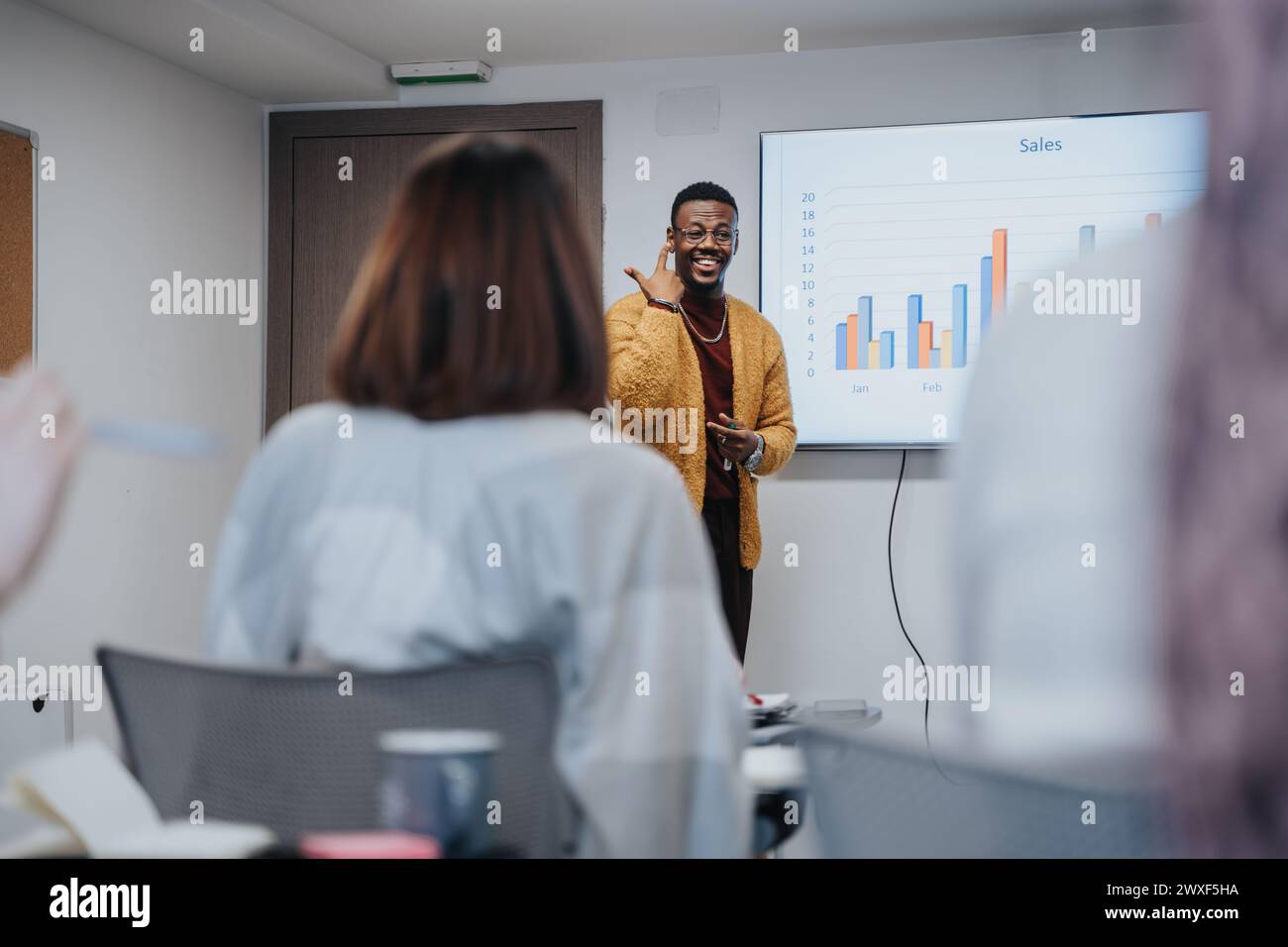 Confident male presenter leads a corporate business meeting, delivering ...