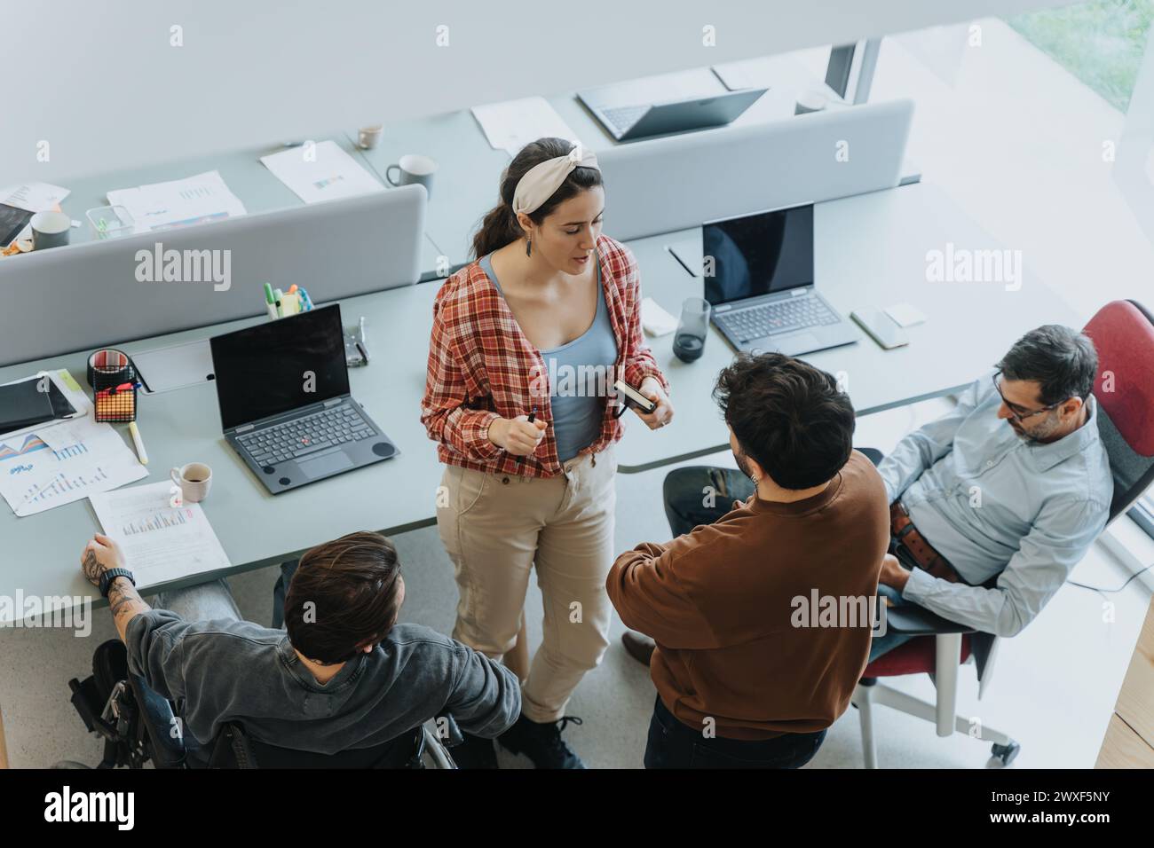 Team of colleagues are engaging in a collaborative discussion in a well ...