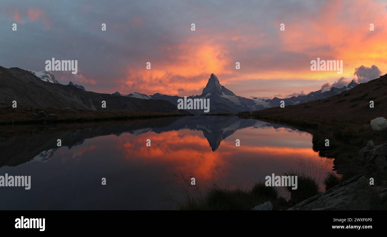 Panorama of sunset with dramatic alpenglow at the high mountain lake ...