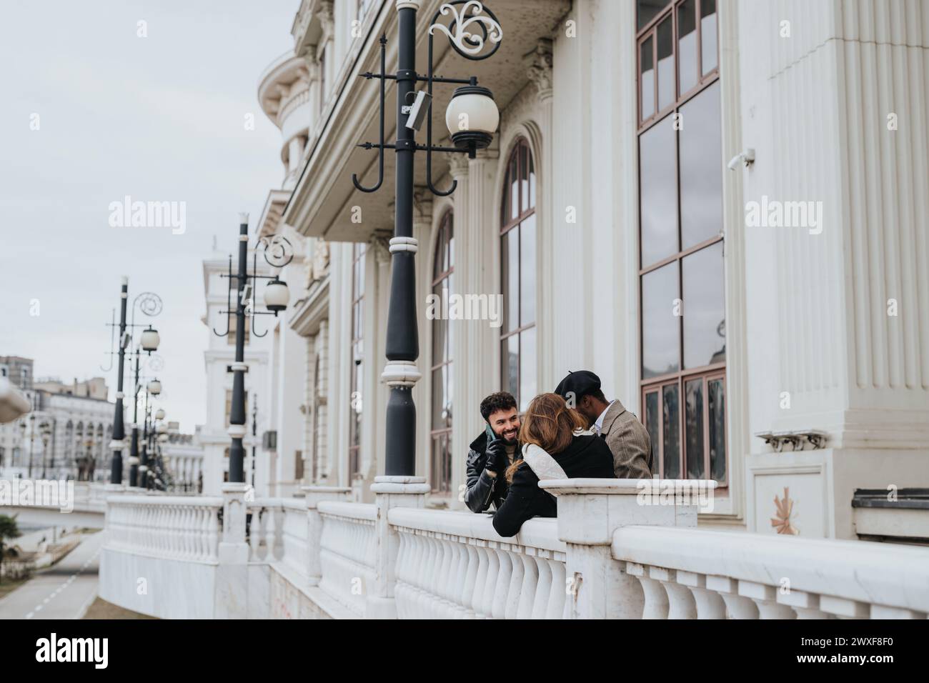 Group of friends enjoying a moment together on an elegant balcony Stock ...