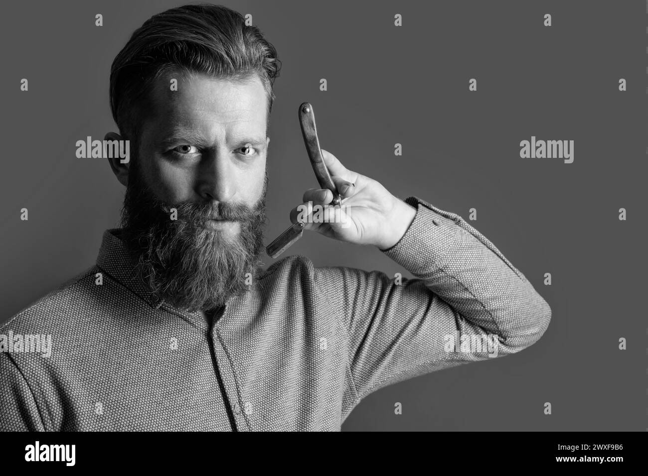 unshaven man shave with blade in barbershop. man in barbershop studio ...