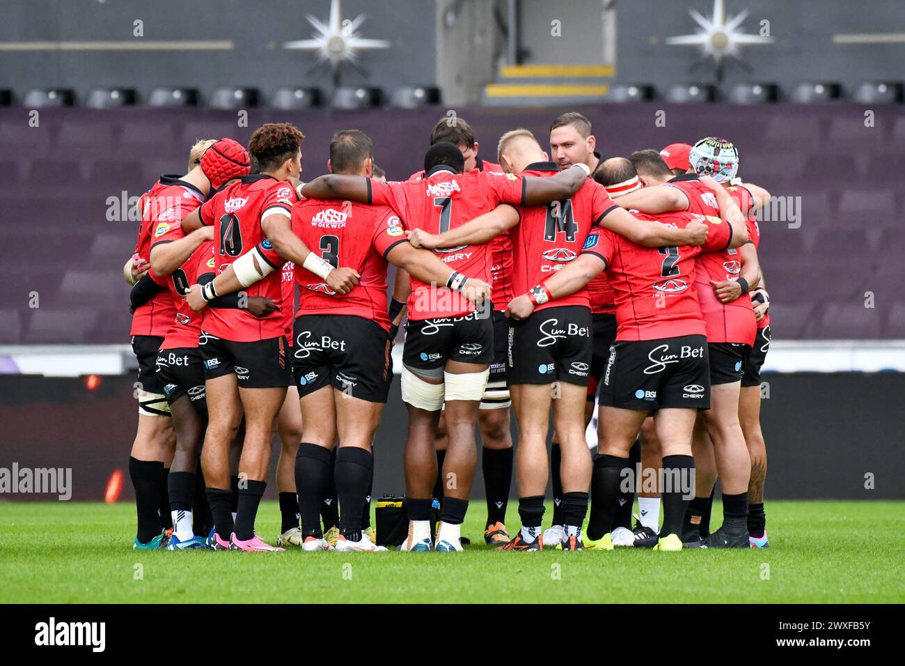 Swansea, Wales. 30 March 2024. The Emirates Lions team in a huddle ...
