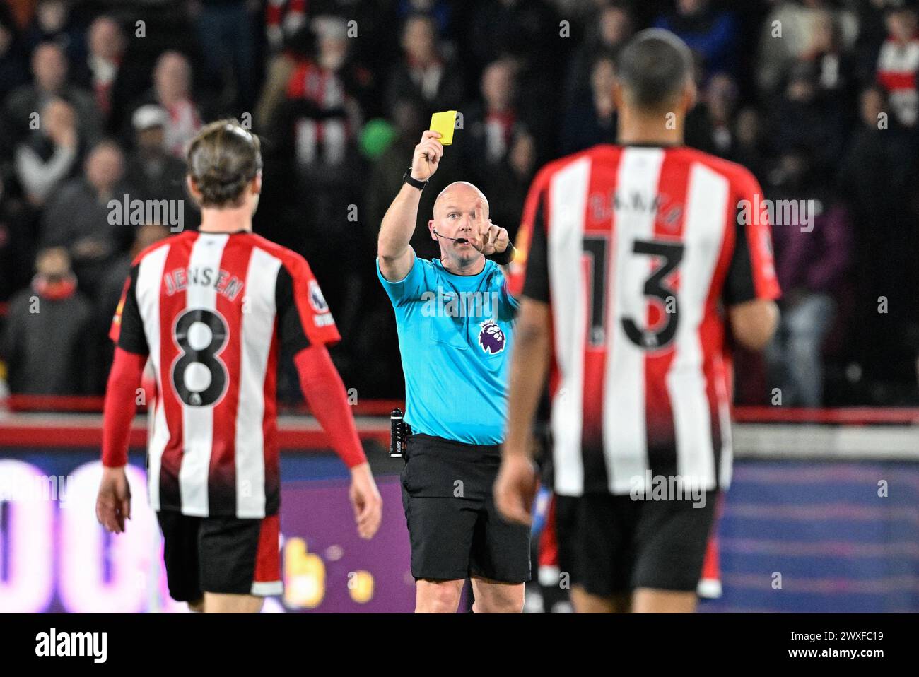 Referee Simon Hooper gives a yellow card to Mathias Zanka Jørgensen of ...