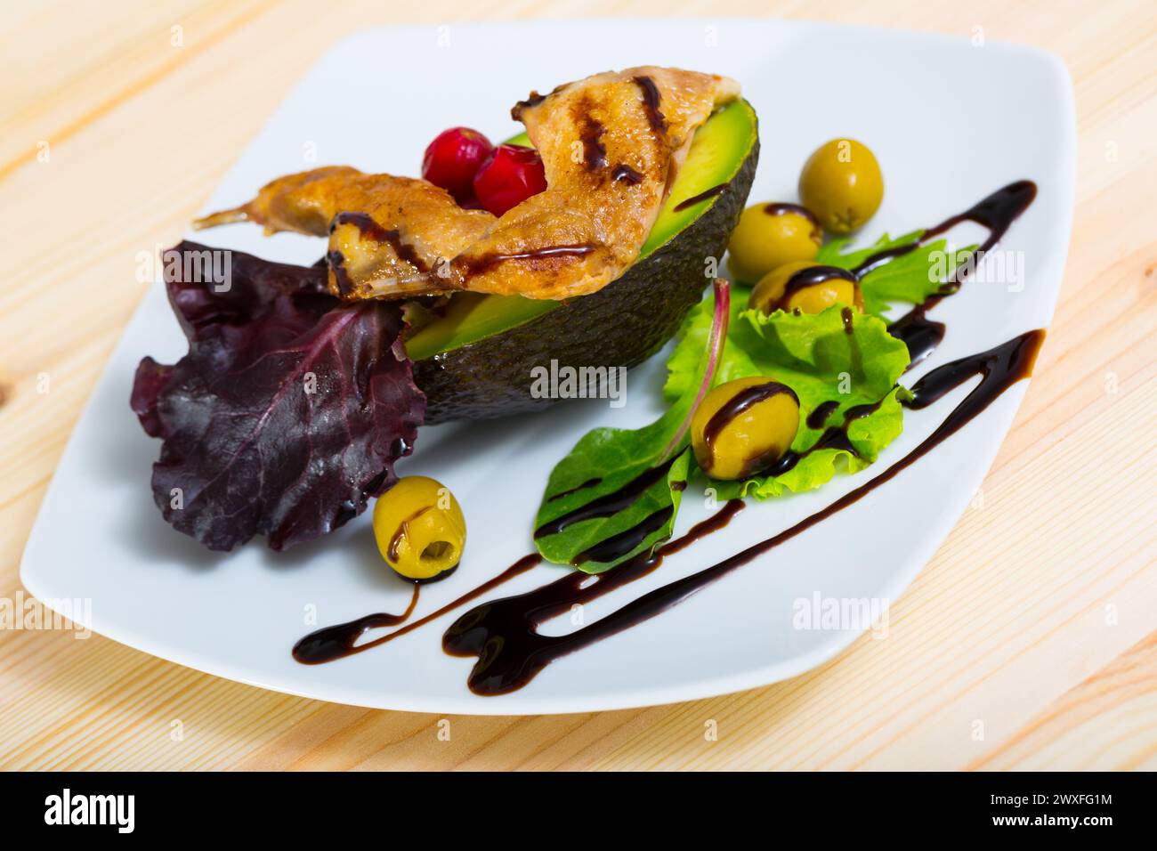 Delicious roasted quail leg quarters seasoned with balsamic garnished ...