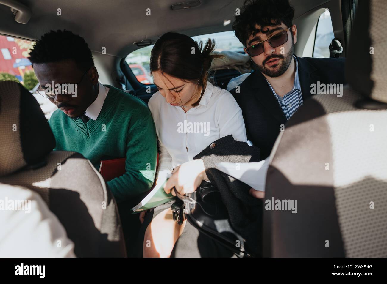 Business colleagues working together during a car ride Stock Photo - Alamy