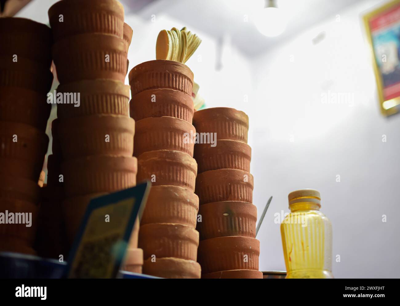 Stacked terracotta lassi glasses. Traditional Indian drink made with ...