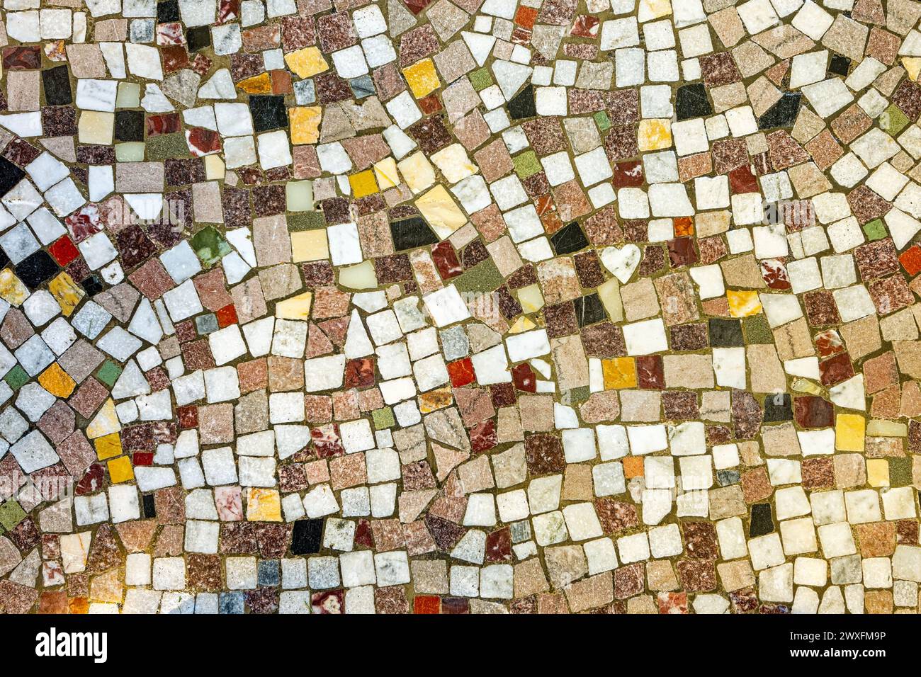 The detail of a floor with irregular patterns of colorful ceramic tiles ...
