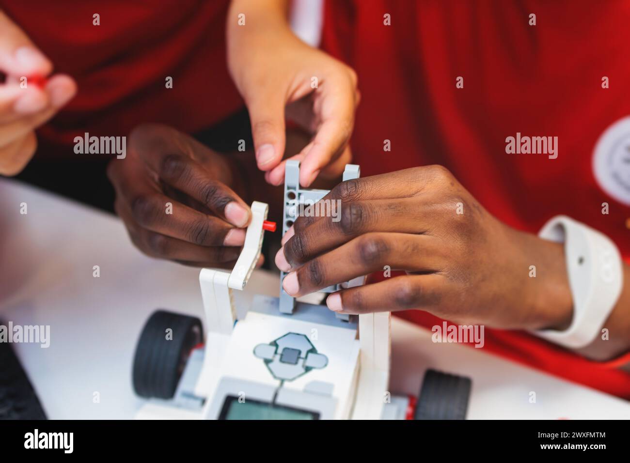 Group of diverse children kids with robotic vehicle model, close-up ...