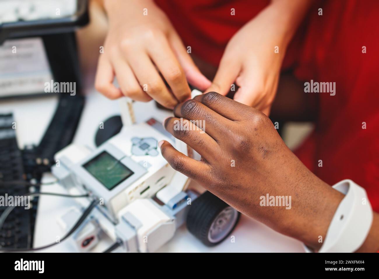 Group of diverse children kids with robotic vehicle model, close-up ...