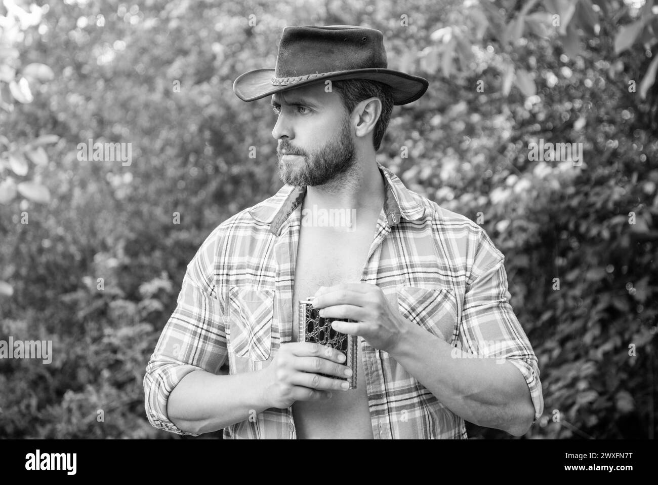 western man with whiskey flask outdoor. western man with whiskey flask ...
