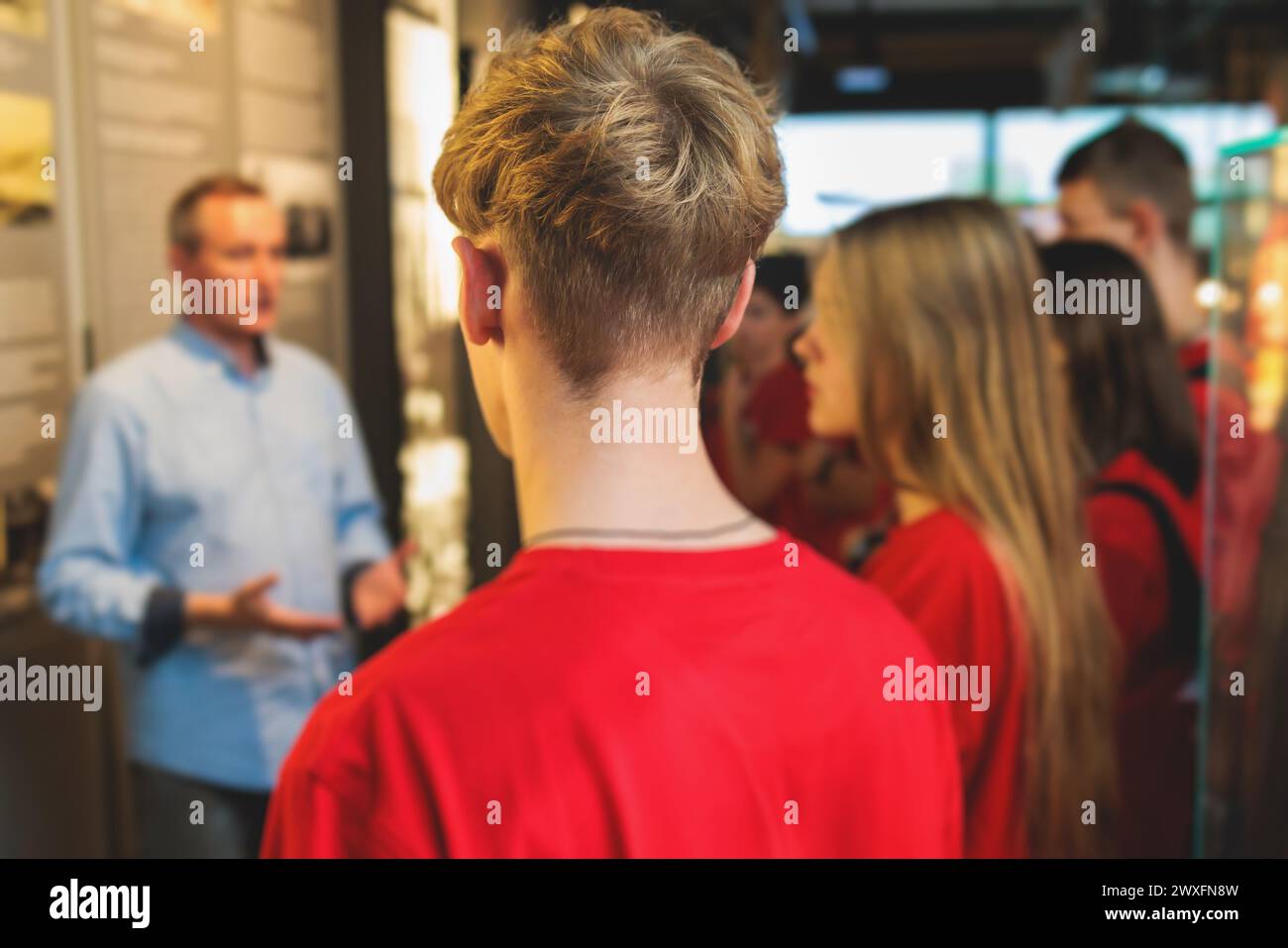Group of students and school pupils in a science museum exhibition ...