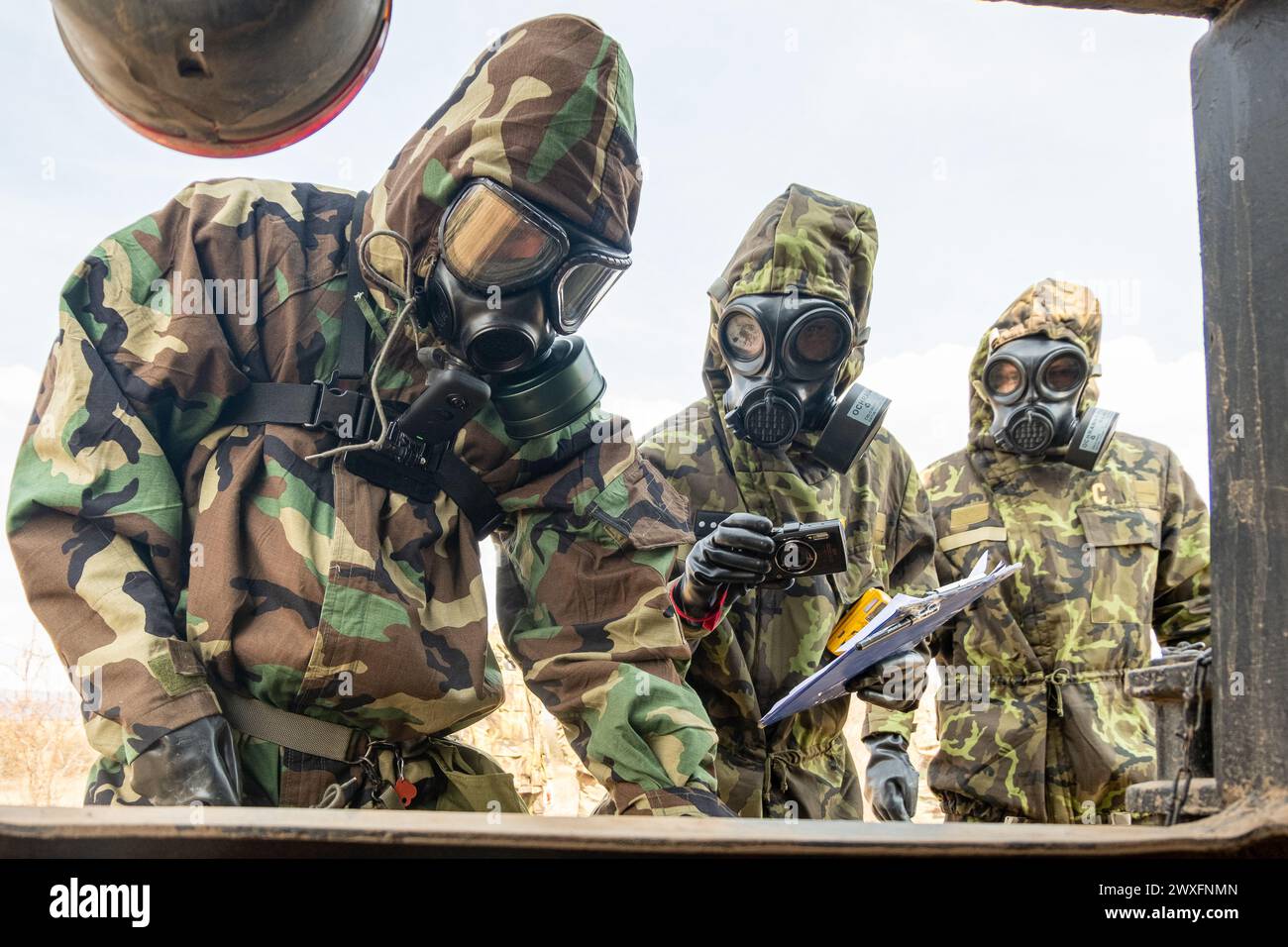 Three men in biohazard suits hi-res stock photography and images - Alamy